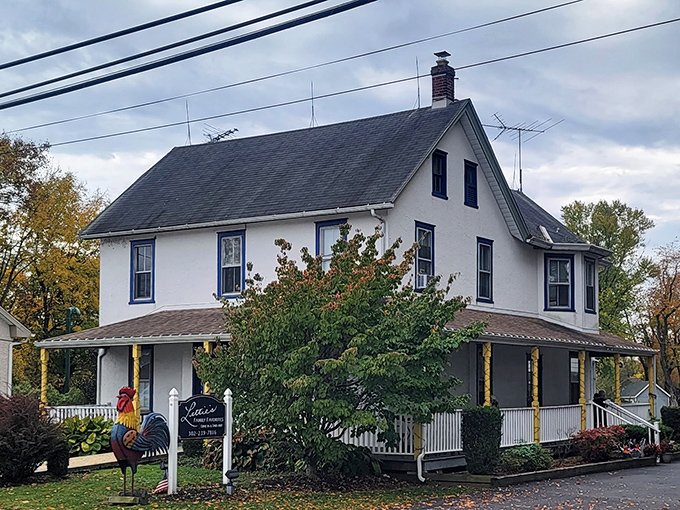 A charming white farmhouse transformed into culinary heaven. Lettie's welcoming porch and vibrant flower beds promise comfort before you even taste the legendary chicken.