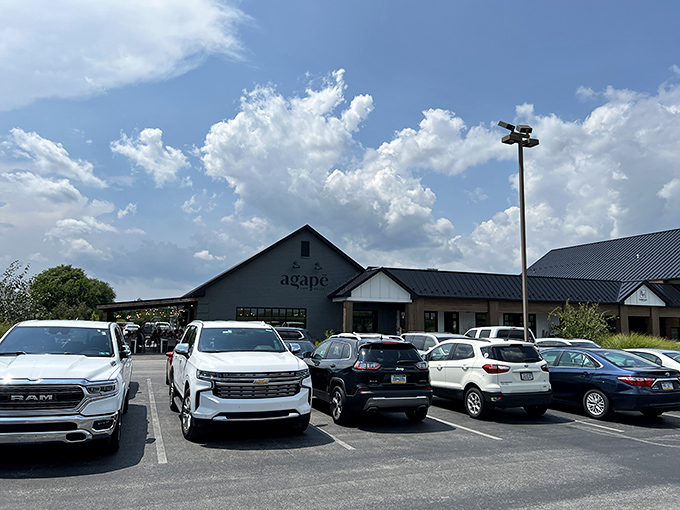 The modern farmhouse exterior of Agapē Cafe & Grille stands proudly against Pennsylvania's blue skies, promising culinary adventures within those charcoal-gray walls.