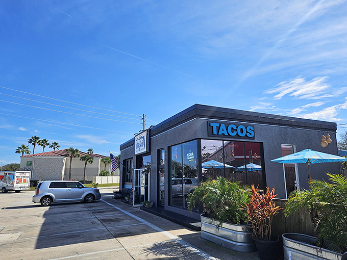 The sleek black exterior with bold orange "TACOS" signage stands as a modern beacon of flavor amid St. Augustine's historic charm.