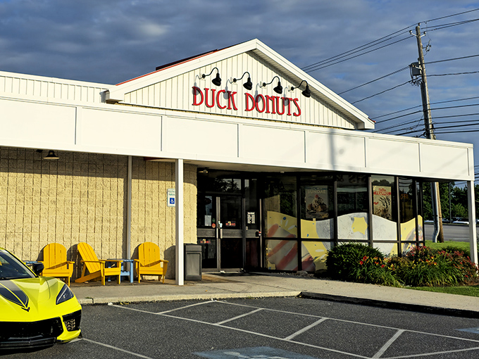 The white facade with bold red lettering promises donut nirvana. Those black lamps aren't just for show &ndash; they're illuminating the path to happiness.