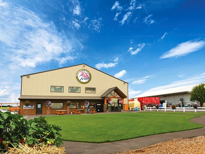 The unassuming exterior of Willamette Valley Pie Company stands like a delicious secret waiting to be discovered, complete with inviting picnic tables for pie enthusiasts.