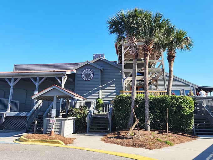 Sunset magic meets architectural brilliance at Old Oyster Factory's waterfront deck, where cocktails and conversation flow as freely as the marsh breeze.