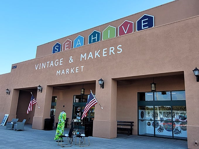The desert-hued exterior of Sea Hive Station beckons with colorful hexagonal signage, promising treasures that'll make your car's suspension beg for mercy.
