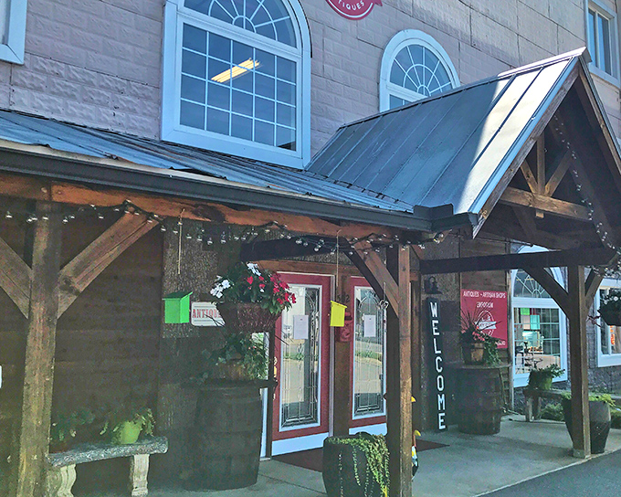 The welcoming facade of Key City Antique Mall beckons with rustic charm and the promise of treasures waiting just beyond those wooden beams.