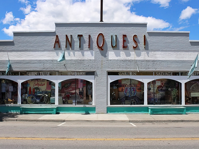 The white facade with its bold "ANTIQUES!" sign is like a siren call to treasure hunters. This isn't just shopping&mdash;it's time travel with a parking lot.