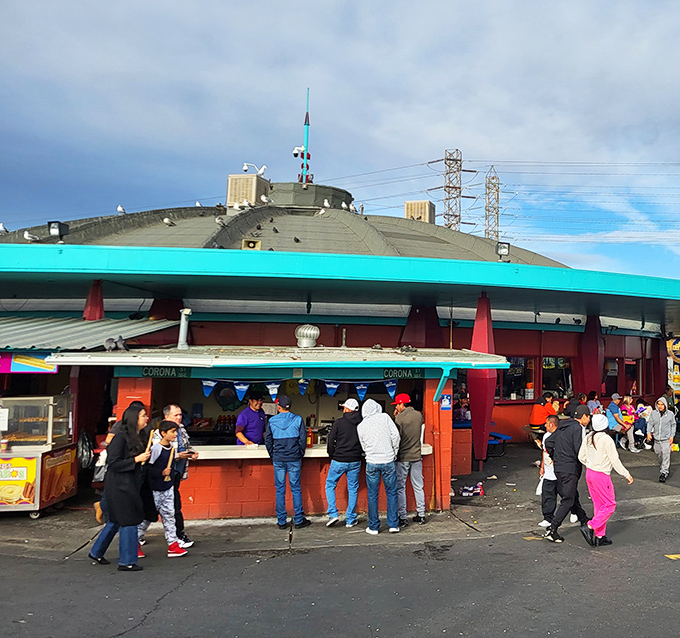 The iconic turquoise-rimmed food pavilion at Oakland Flea Market buzzes with hungry shoppers. Where culinary adventures begin and shopping stamina gets refueled!