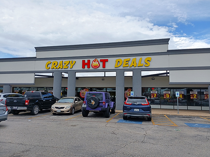 The bright yellow and red signage of Crazy Hot Deals beckons bargain hunters like a retail lighthouse on Westheimer Road.