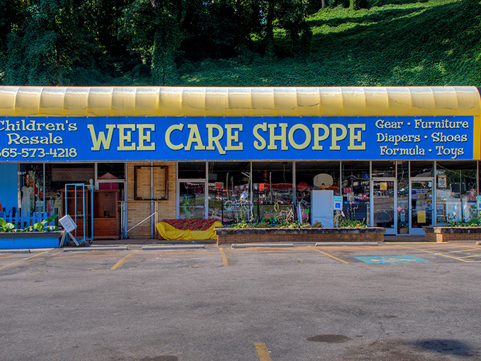The blue-awninged facade of Wee Care Shoppe stands like a beacon of bargain hope for parents, with colorful outdoor merchandise hinting at treasures within.