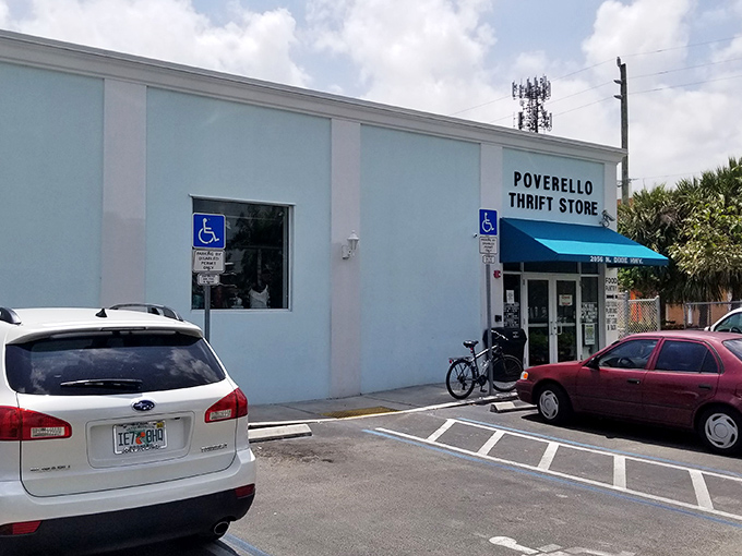 The unassuming exterior with its cheerful blue awning is like finding a secret portal to bargain heaven. No fancy frills needed when treasures await inside.