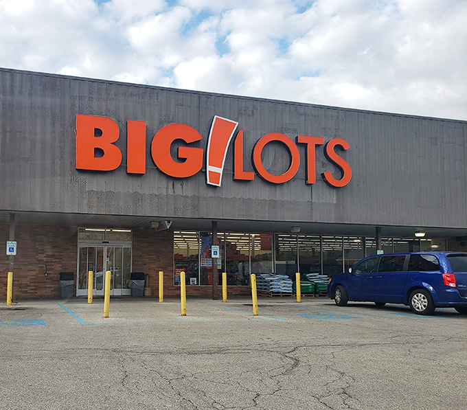 The iconic orange and black Big Lots sign stands like a beacon of bargain possibilities, promising treasure hunts where your wallet actually wins for once.
