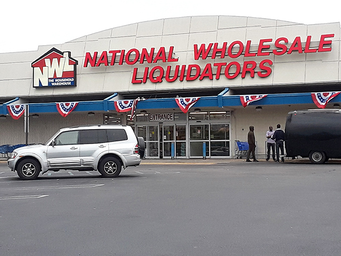 The iconic red, white, and blue sign beckons bargain hunters like a retail lighthouse. National Wholesale Liquidators stands ready to transform shopping lists into treasure maps.