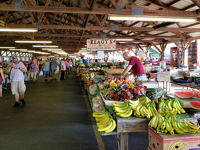The wooden beams overhead create a cathedral-like atmosphere for this temple of fresh produce, where bananas are displayed with the care usually reserved for fine art.