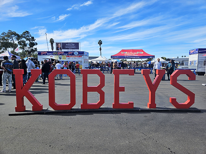 The iconic red KOBEY'S sign welcomes treasure hunters to San Diego's weekend wonderland, where bargain dreams come true under perfect California skies.