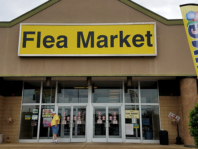 The unassuming yellow sign beckons like a treasure map's X-marks-the-spot. Behind these doors, bargain hunters find their paradise.