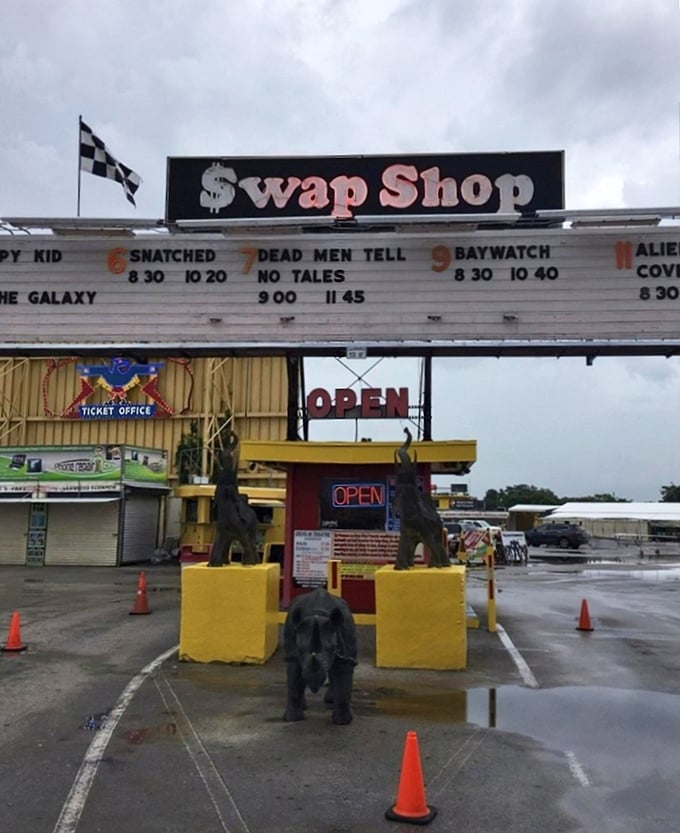 The iconic Swap Shop entrance, complete with movie listings and quirky elephant statues, welcomes treasure hunters to Florida's retail wonderland.