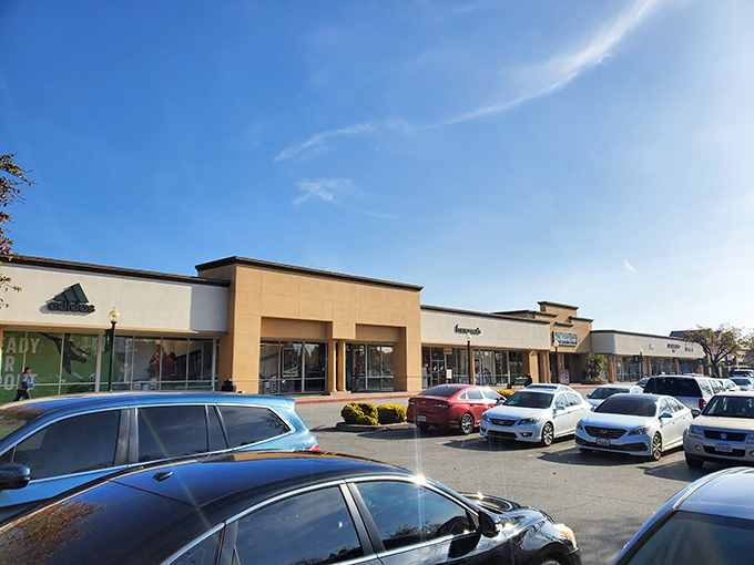 Brooks Brothers stands sentinel at dusk, promising preppy perfection without the Ivy League price tag. Shopping salvation awaits within.