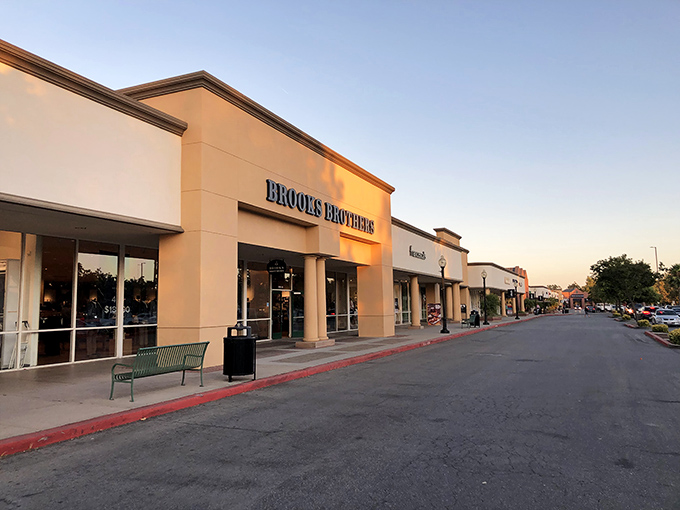Brooks Brothers stands sentinel at dusk, promising preppy perfection without the Ivy League price tag. Shopping salvation awaits within.