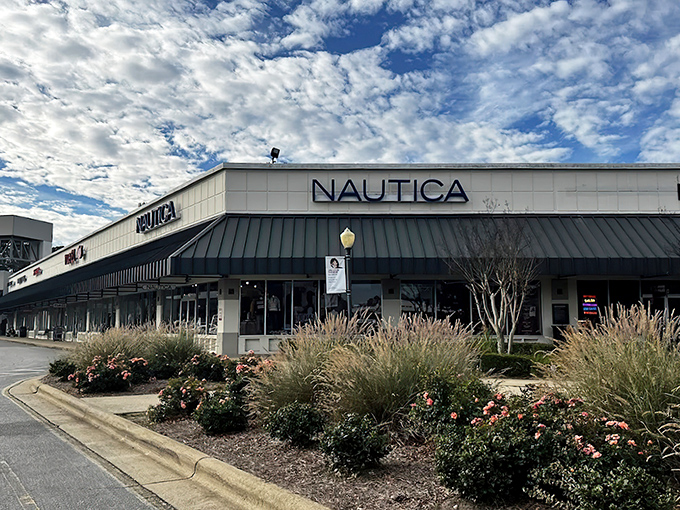 The iconic cream-colored facades with green awnings welcome bargain hunters to Carolina Premium Outlets, where retail therapy meets actual savings.