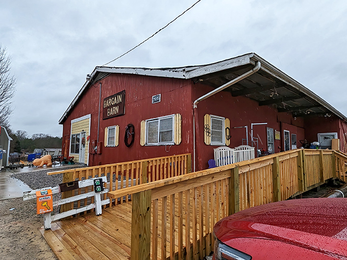 The iconic red exterior of Bargain Barn stands proudly against the Carolina blue sky, promising treasures within that big box stores could never deliver.