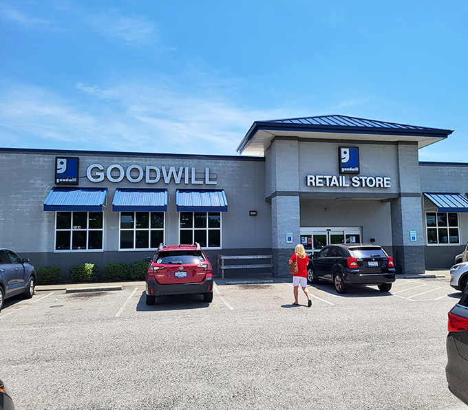 The unassuming exterior of Palmetto Goodwill belies the treasure trove within. That blue roof signals bargain paradise to seasoned thrifters.