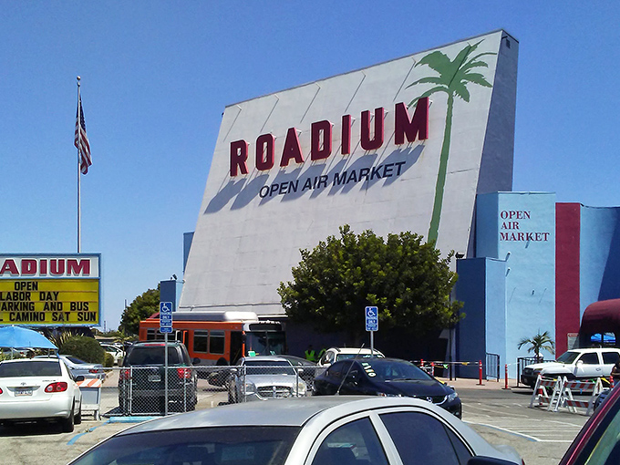 The iconic blue and white facade of The Roadium stands like a retro movie marquee, promising treasures within rather than feature films. 