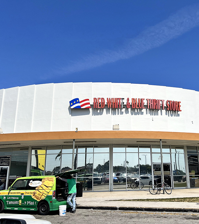 The iconic white facade of Red White & Blue Thrift Store stands proudly against the Florida sky, a patriotic beacon for bargain hunters everywhere.