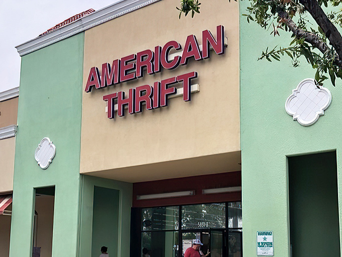 The mint-green facade of American Thrift Store stands out like a beacon of bargain possibilities, promising treasures behind those "NOW OPEN" doors.