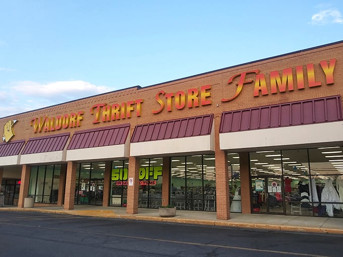 The unassuming storefront of Waldorf Thrift Store Family beckons with its cheerful yellow sign, promising treasures within that big-box retailers can only dream about.
