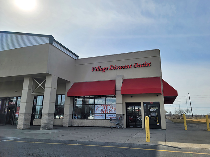 The iconic red awnings of Village Discount Outlet beckon bargain hunters like a retail lighthouse guiding ships to treasure-filled shores.