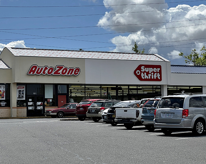The iconic red SuperThrift sign beckons treasure hunters like a retail lighthouse, promising adventures in secondhand splendor just beyond those glass doors.