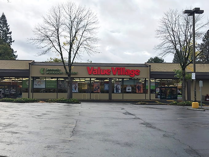 The iconic red Value Village sign beckons like a lighthouse to shipwrecked shoppers tired of paying full retail prices.