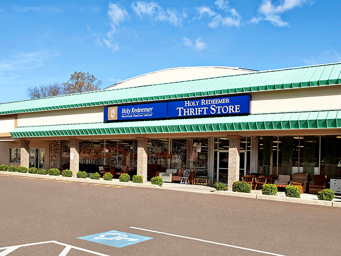 The unassuming exterior of Holy Redeemer Thrift Shop&mdash;where bargain hunters' dreams and Marie Kondo's nightmares collide in glorious retail harmony. 