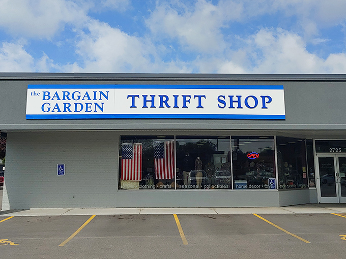 The unassuming storefront belies the treasure trove within. American flags frame the entrance like sentinels guarding a portal to bargain paradise.
