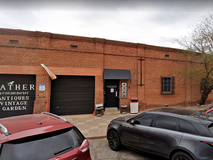 The unassuming brick exterior of Gather hides a universe of vintage treasures within, like a time-travel portal disguised as a warehouse in Tucson.
