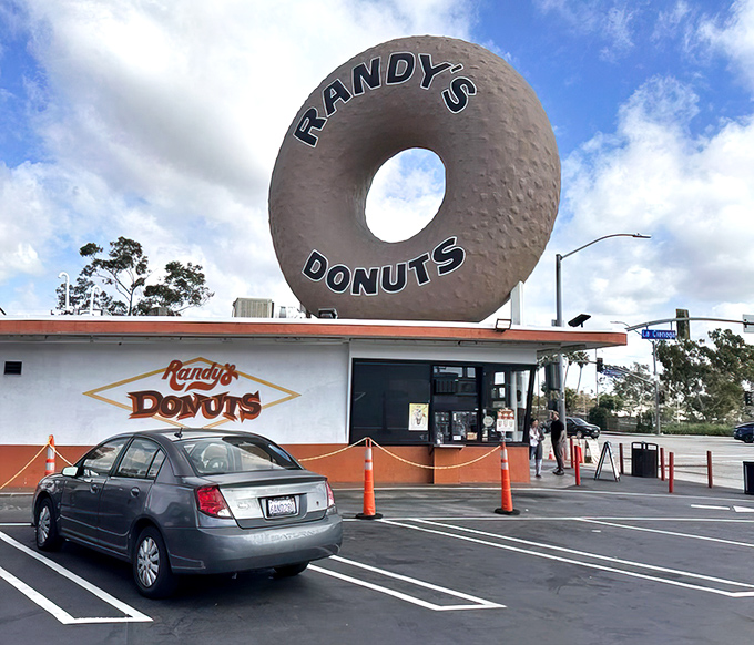 The mothership has landed! Randy's iconic 32-foot donut beckons sugar enthusiasts from miles away, a beacon of sweetness against the California sky.