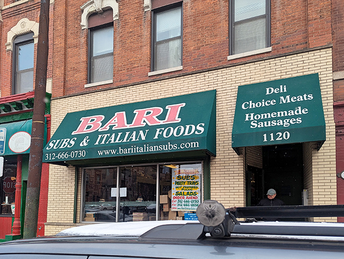 The iconic green awning of Bari Foods stands as a beacon of sandwich salvation on Chicago's Grand Avenue, promising Italian delights within those brick walls.