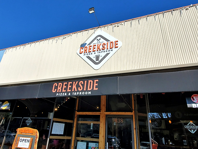 The unassuming exterior of Creekside Pizza & Taproom &ndash; proof that culinary treasures often hide behind modest facades.