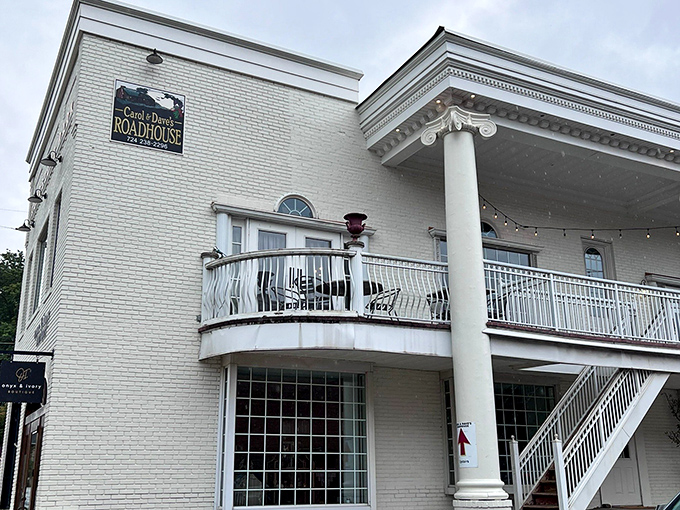The stately white brick exterior of Carol & Dave's Roadhouse stands like a culinary lighthouse, beckoning hungry travelers with its elegant columns and promise of comfort food paradise.
