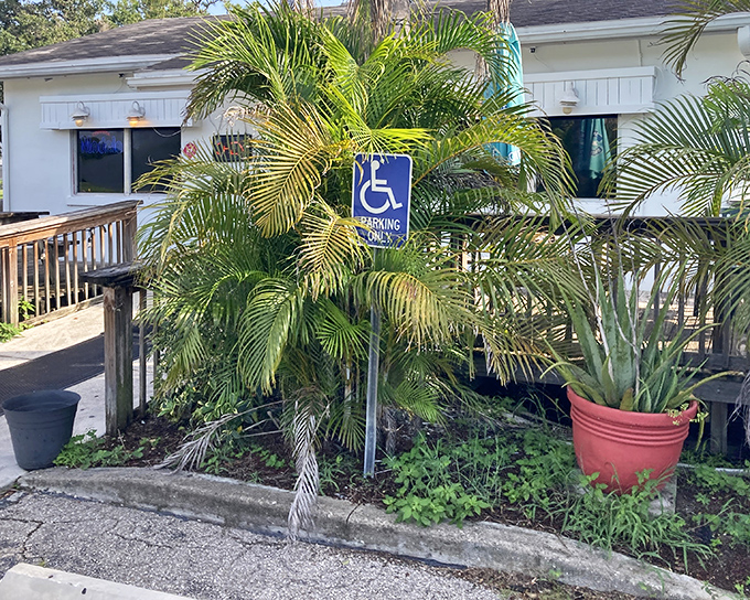 The unassuming exterior of Leo's French Toast House, where palm trees and a wooden ramp welcome you to one of Alva's best-kept culinary secrets.