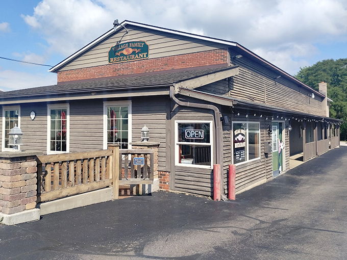 The wooden exterior of Village Family Restaurant beckons like an old friend, complete with sunny yellow umbrellas promising outdoor dining when Ohio weather cooperates.