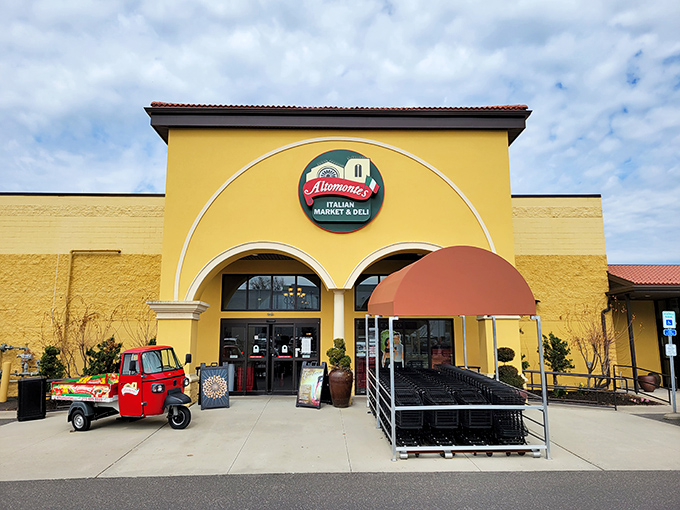 The sunshine-yellow facade of Altomonte's stands like a beacon of culinary promise, complete with a charming red Italian delivery vehicle that practically screams "authenticity awaits inside!"