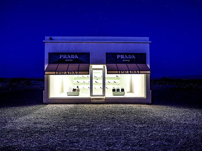 Prada after dark&mdash;where high fashion meets high desert under a canopy of stars. The illuminated storefront creates an otherworldly glow against the inky Texas night.