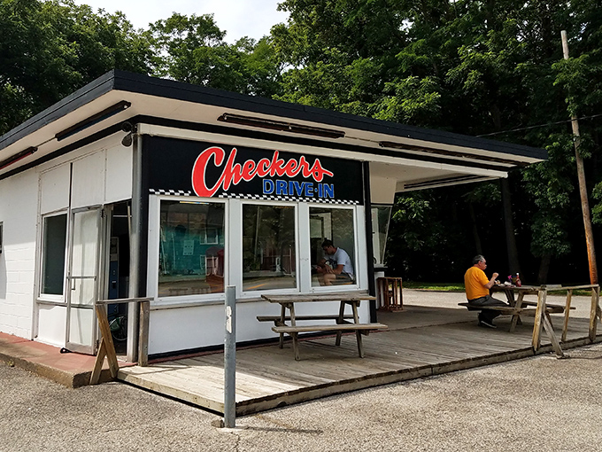 The iconic black exterior with red and blue lettering announces you've arrived at burger paradise. No fancy frills, just the promise of greatness ahead.