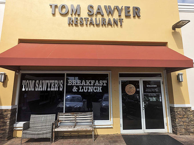 The yellow facade with its distinctive red awning stands like a beacon of breakfast hope in Boca Raton. No pretension, just promise.
