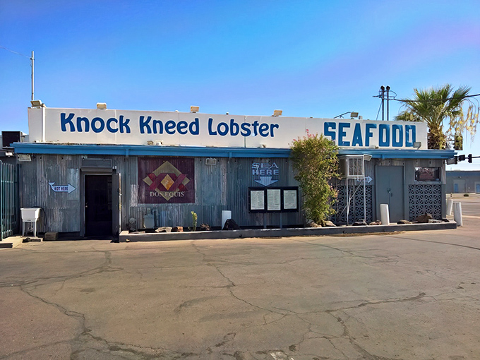 The unassuming blue facade of Knock Kneed Lobster stands like a mirage in the desert—proof that great seafood doesn't need ocean views to be spectacular.