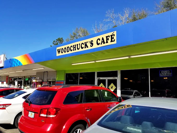 The vibrant blue exterior of Woodchuck's Cafe announces itself with colorful street art and a distinctive green awning&mdash;Tallahassee's breakfast rebellion in architectural form.