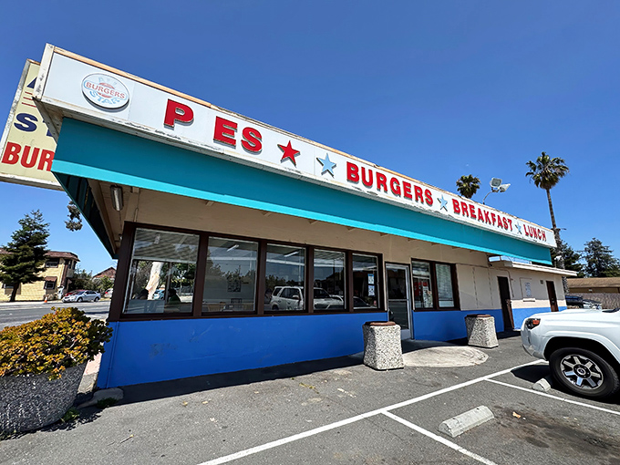 The bright turquoise exterior of Allstar Burger stands out like a beacon of hope for the hungry, complete with red stars promising burger salvation.