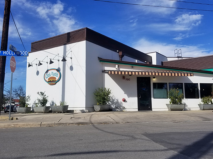 Colorful papel picado banners welcome you to burger paradise. The "Enter Here" sign might as well say "Abandon Diet All Ye Who Enter."