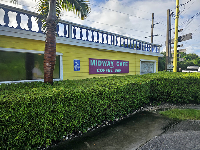 Welcome to paradise! Midway Cafe's unassuming exterior hides culinary treasures behind its weathered charm and inviting stone table setup.