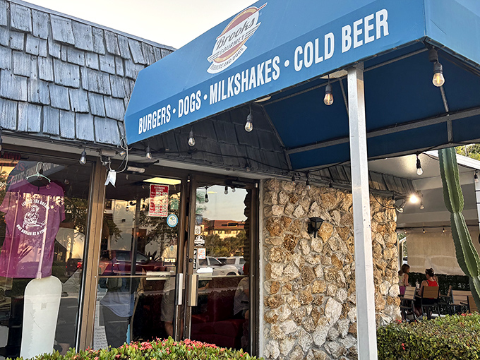 The unassuming blue awning of Brooks Burgers beckons from downtown Naples, promising simple pleasures that outshine their fancy neighbors.